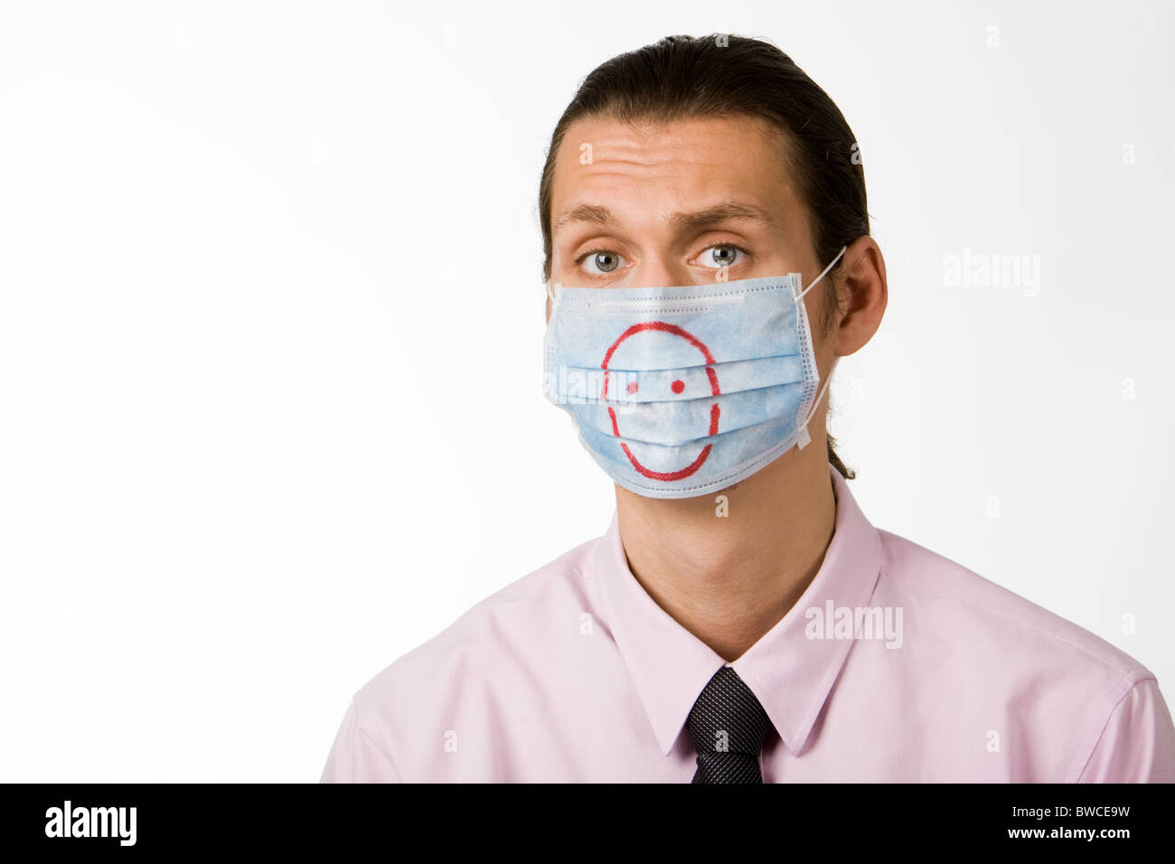 Portrait of sad man wearing protective mask with red pig’s snout drawn ...