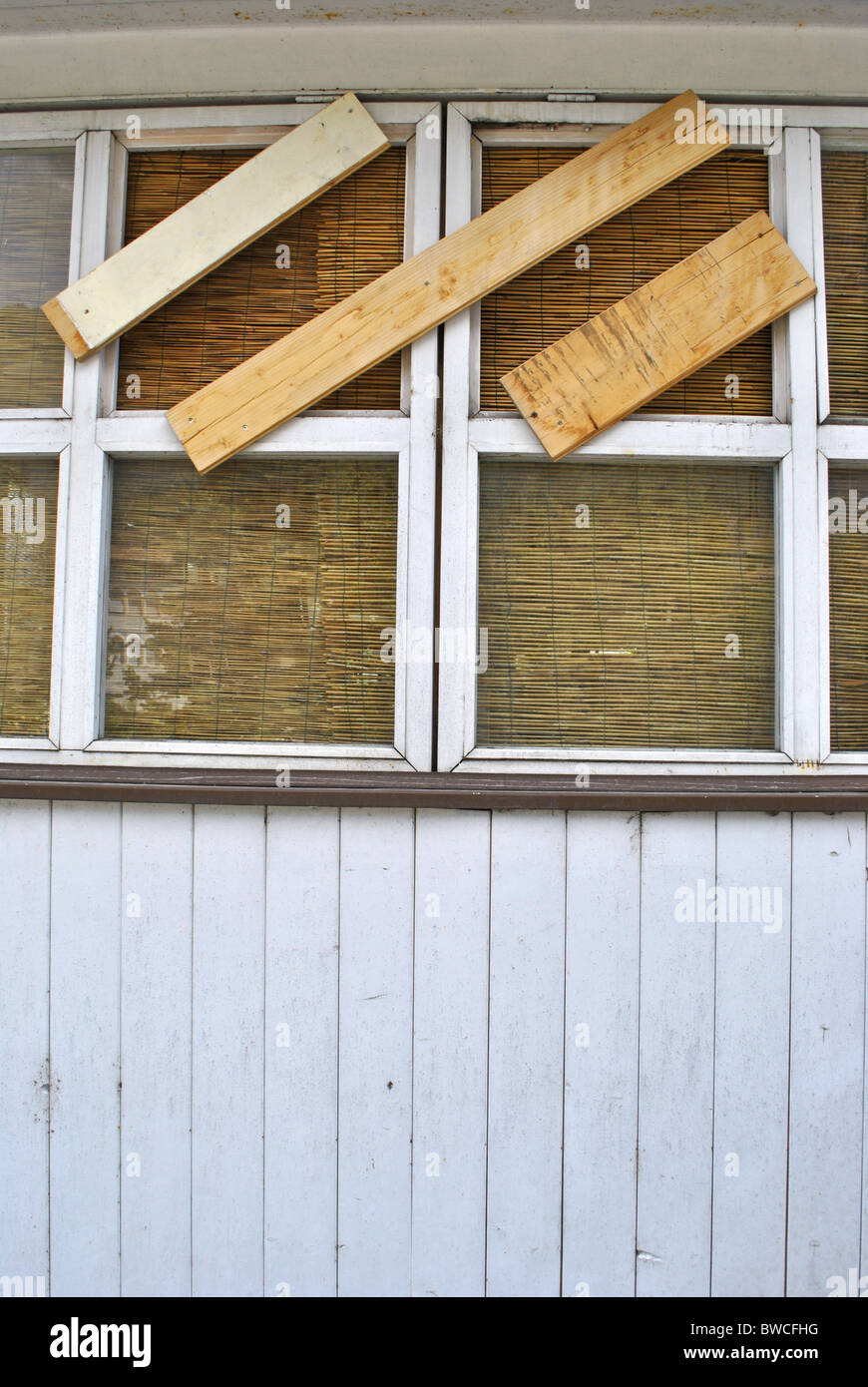 broken window closed with wooden planks Stock Photo - Alamy