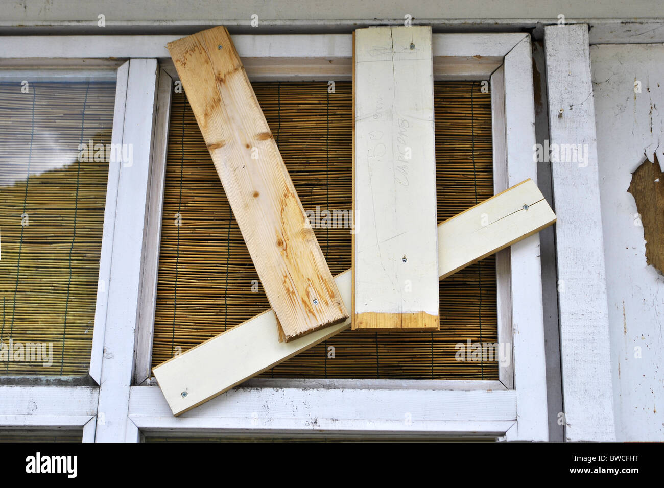 broken window closed with wooden planks Stock Photo - Alamy