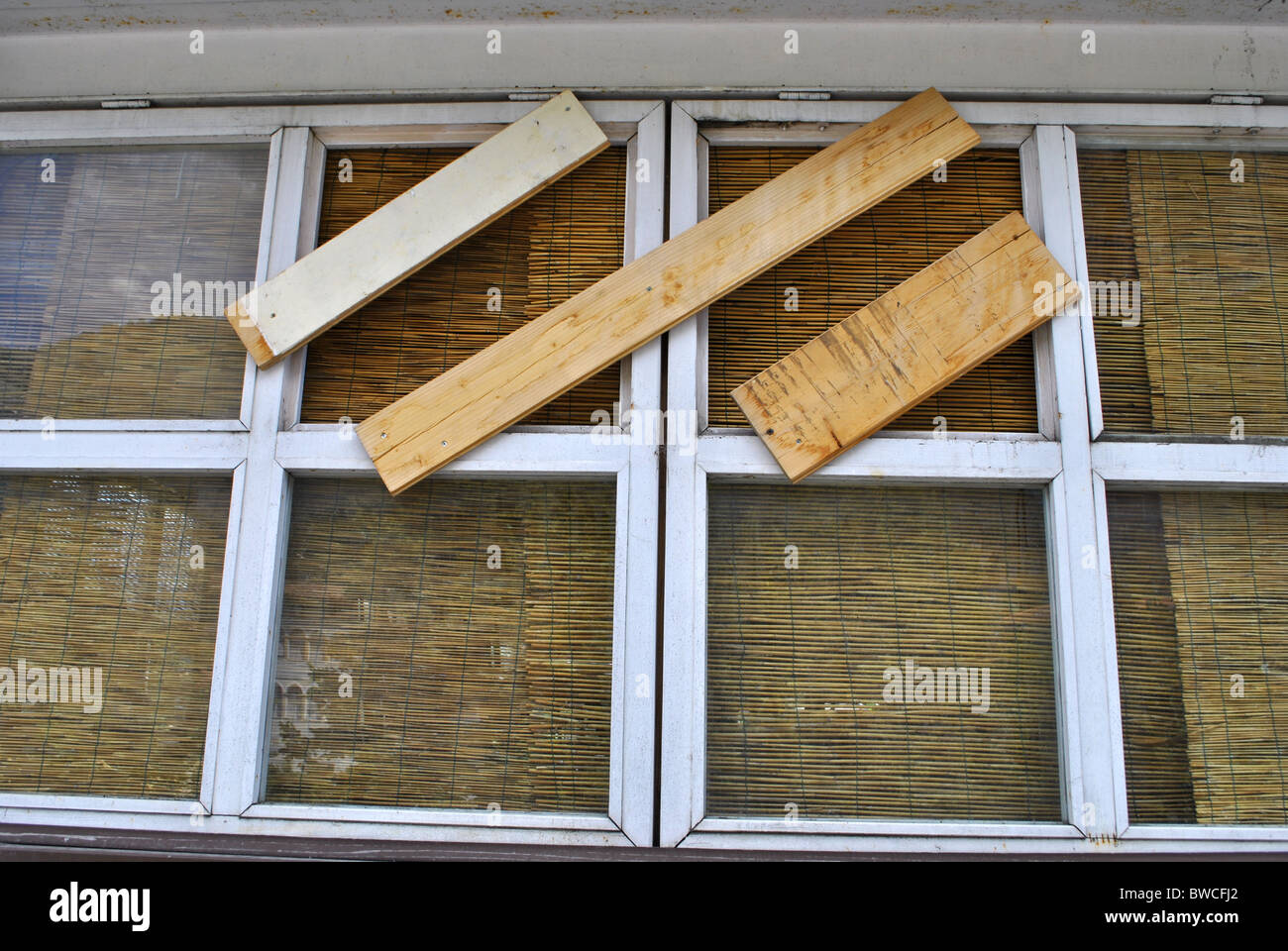 broken window closed with wooden planks Stock Photo - Alamy