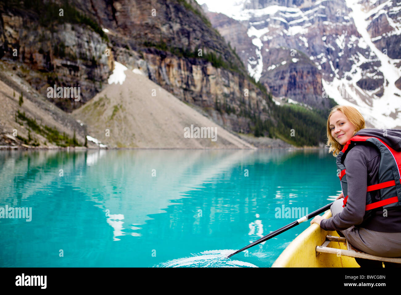 A woman canoeing on Moraine Lake, a tight crop with copy space Stock ...