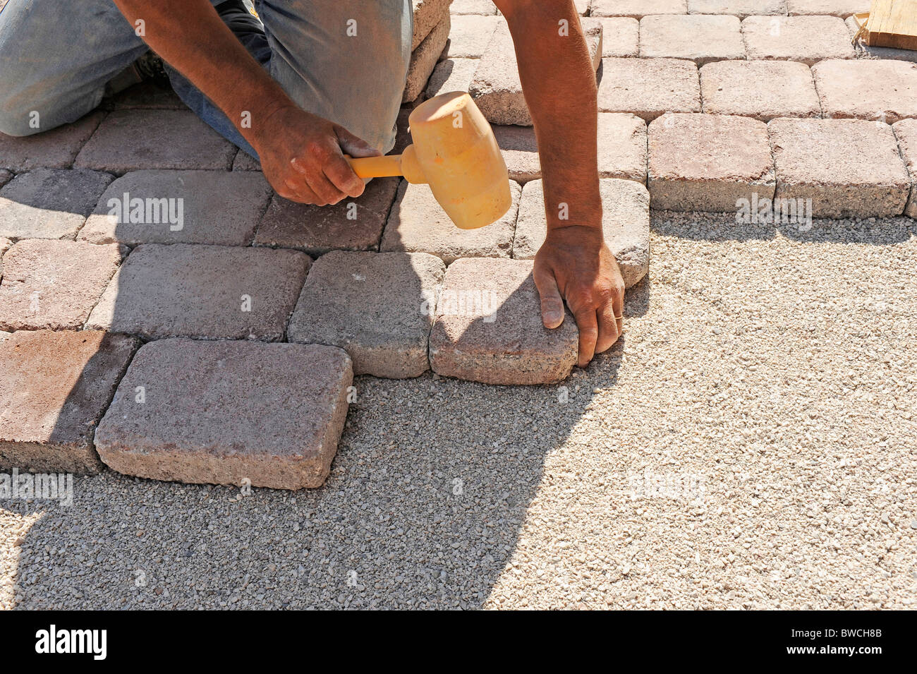 man at work paving stones with rectangular Stock Photo - Alamy