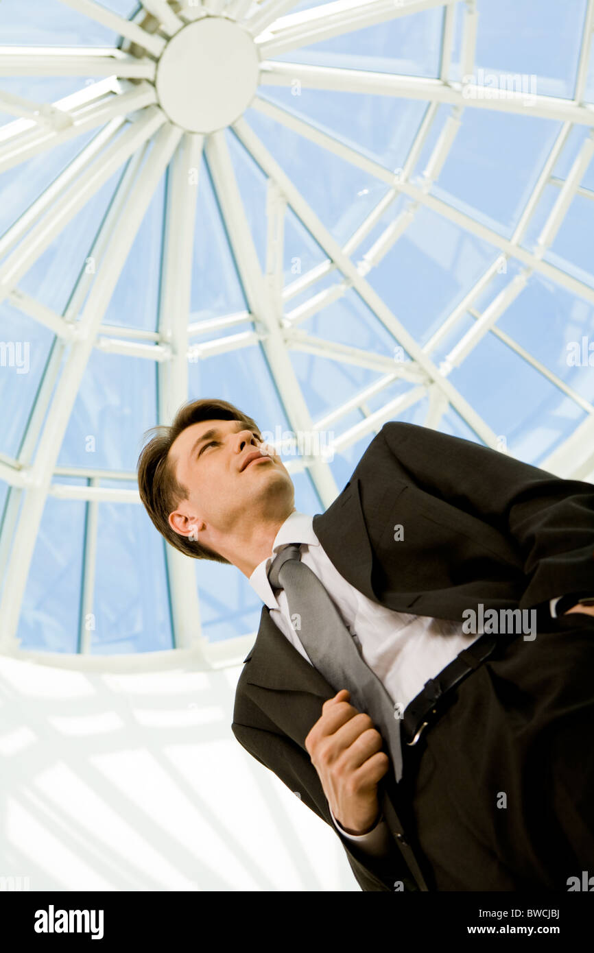 Below view of confident businessman in suit looking aside Stock Photo ...