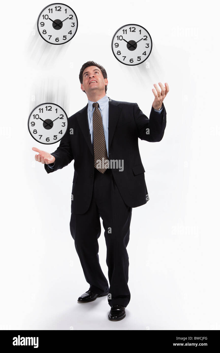 USA, Illinois, Metamora, Studio shot of businessman juggling with ...
