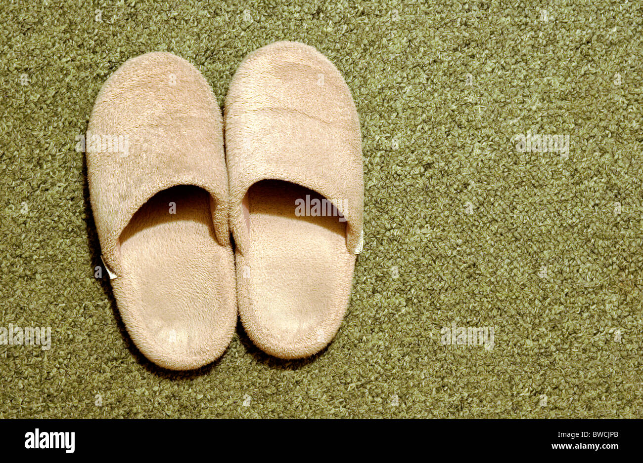 Pair of slippers on carpet Stock Photo - Alamy