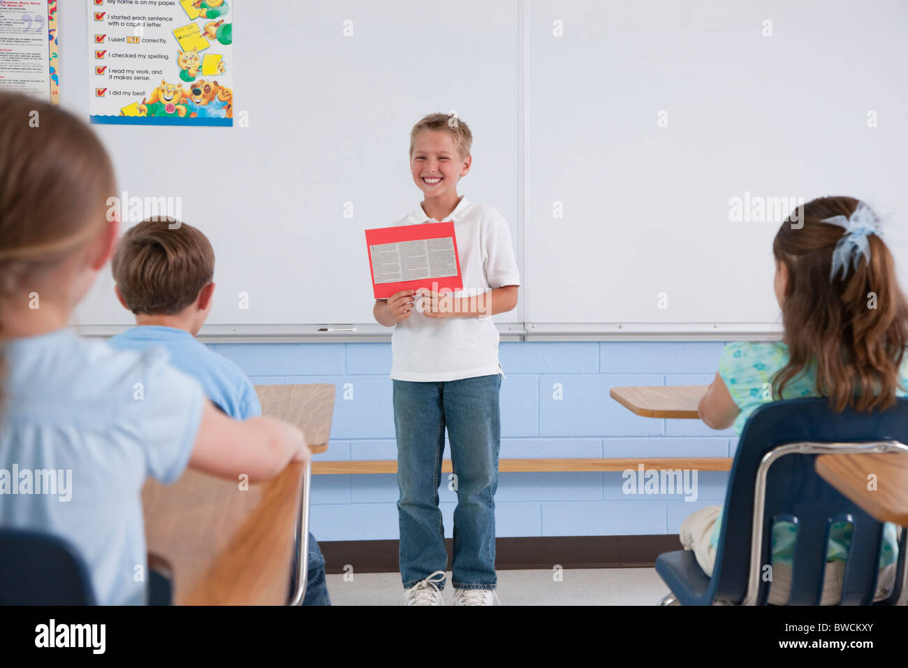 USA, Illinois, Metamora, School boy presenting work to class (8-9) in ...