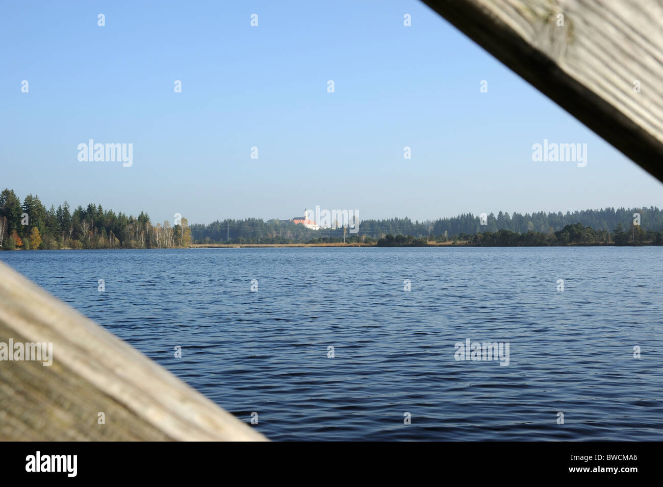 View of Kirchsee and monastery Sachsenkam through wooden parapet ...