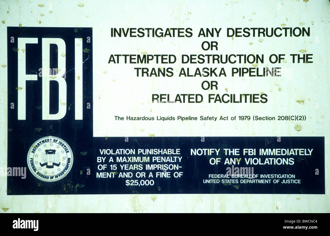 An FBI warning sign on the side of the Trans-Alaskan Oil Pipeline Stock ...
