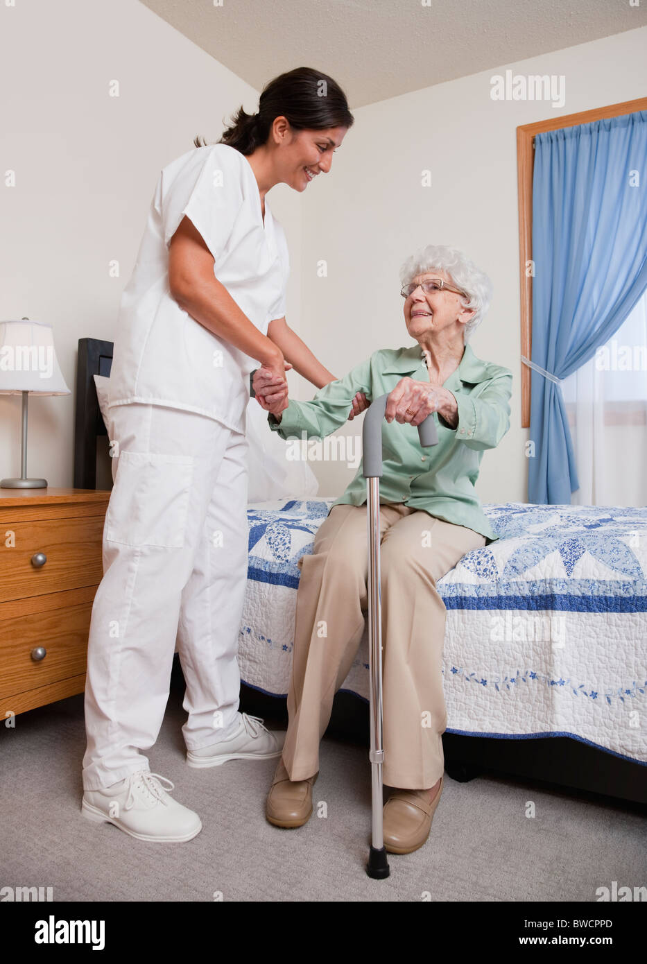 USA, Illinois, Metamora, Nurse helping senior woman with cane Stock ...
