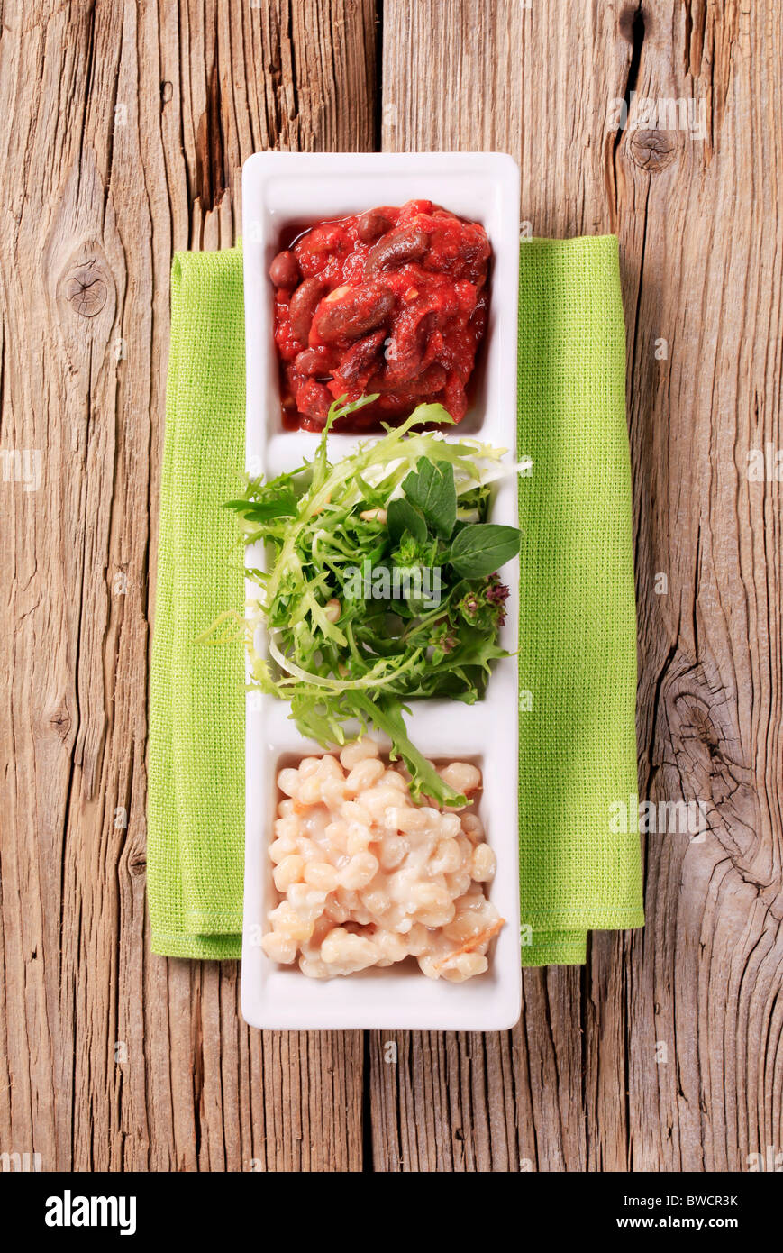White beans, red bean salsa and salad greens Stock Photo - Alamy