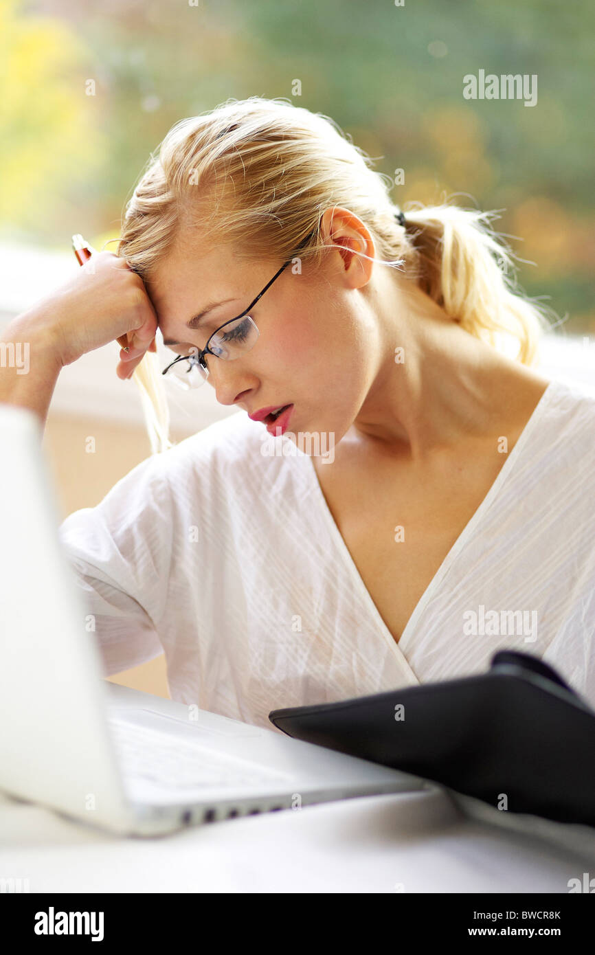 Woman stressed in office Stock Photo - Alamy