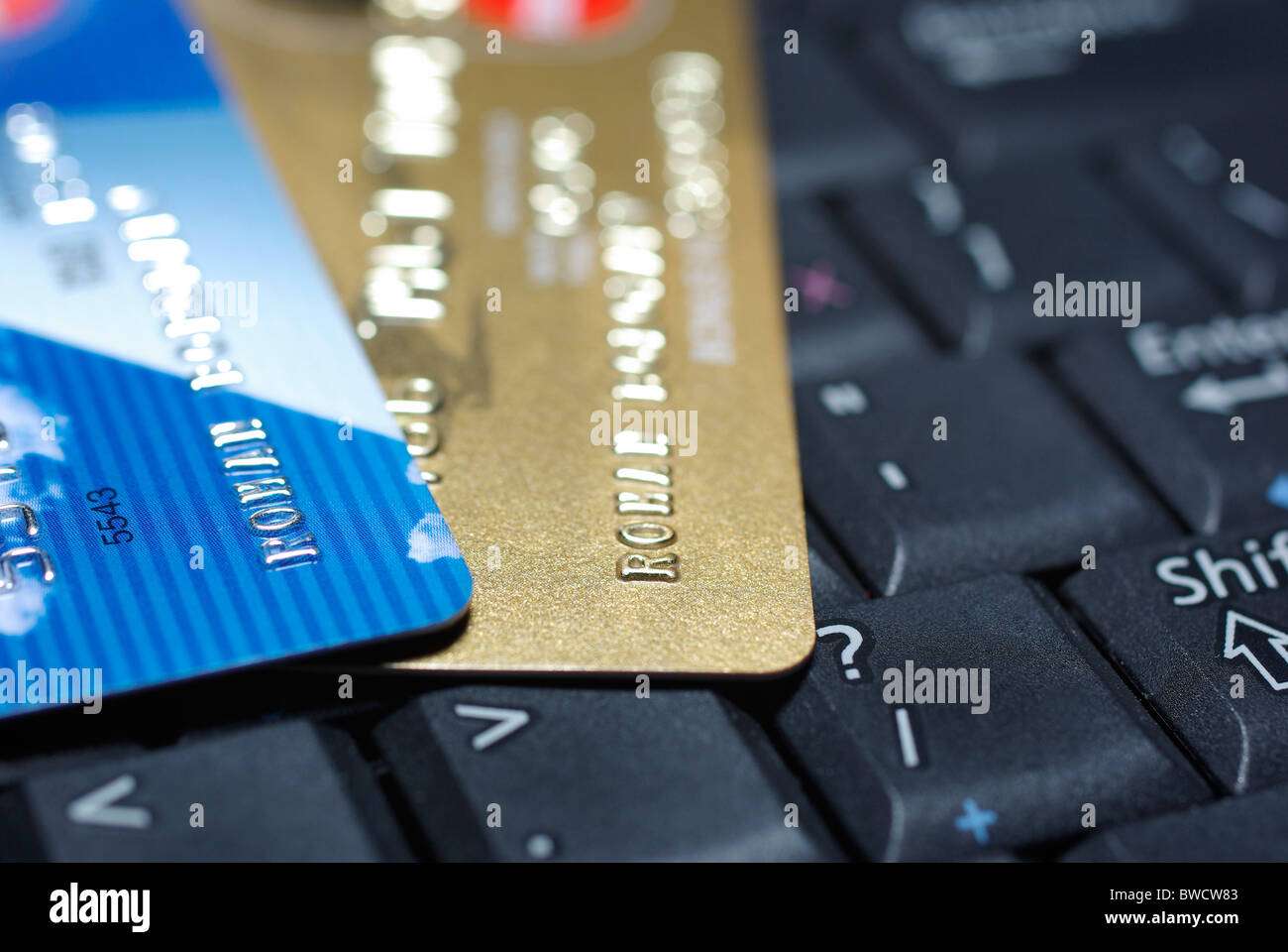 Credit cards laying on laptop's keyboard Stock Photo - Alamy