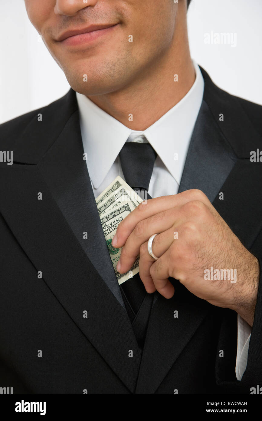 USA, Illinois, Metamora, Businessman taking out money from jacket Stock ...