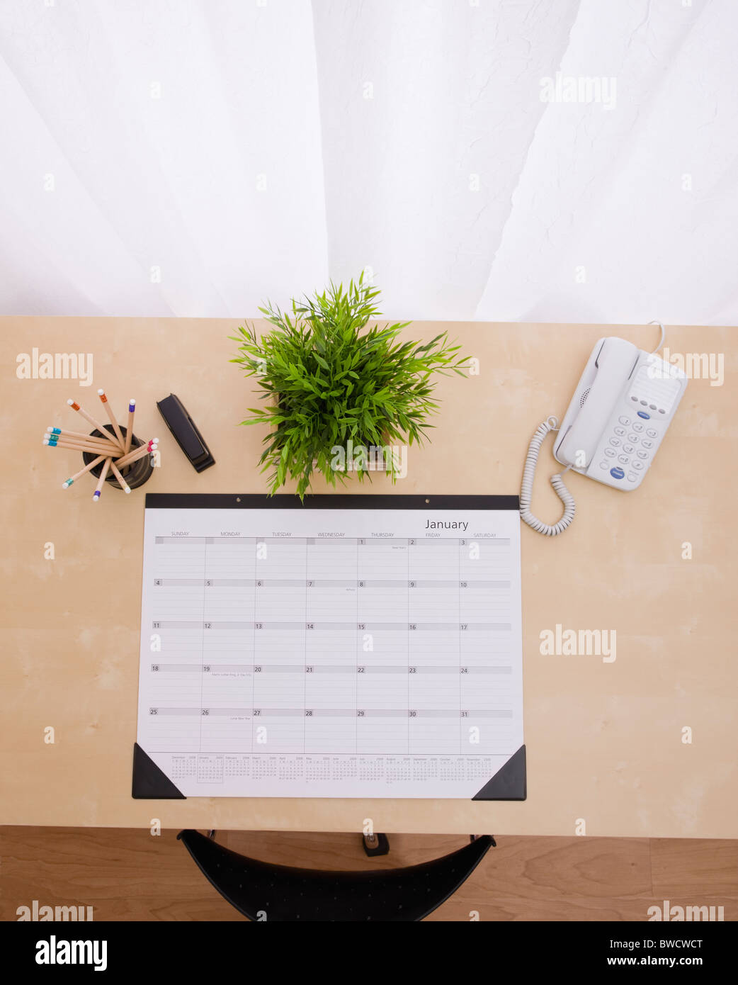 Wall calendar on desk Stock Photo - Alamy