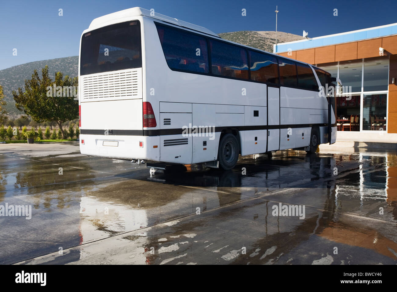 White tourist bus parked outside restaurant, Turkey Stock Photo - Alamy