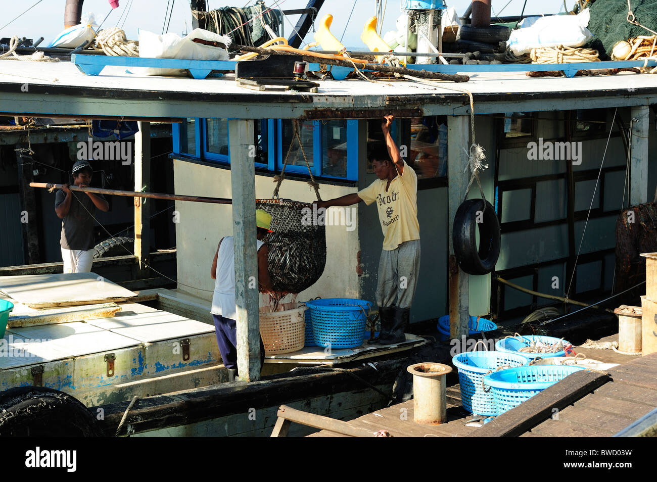 Fishing boat unloading catch on waterfront in Sandakan in north-east ...