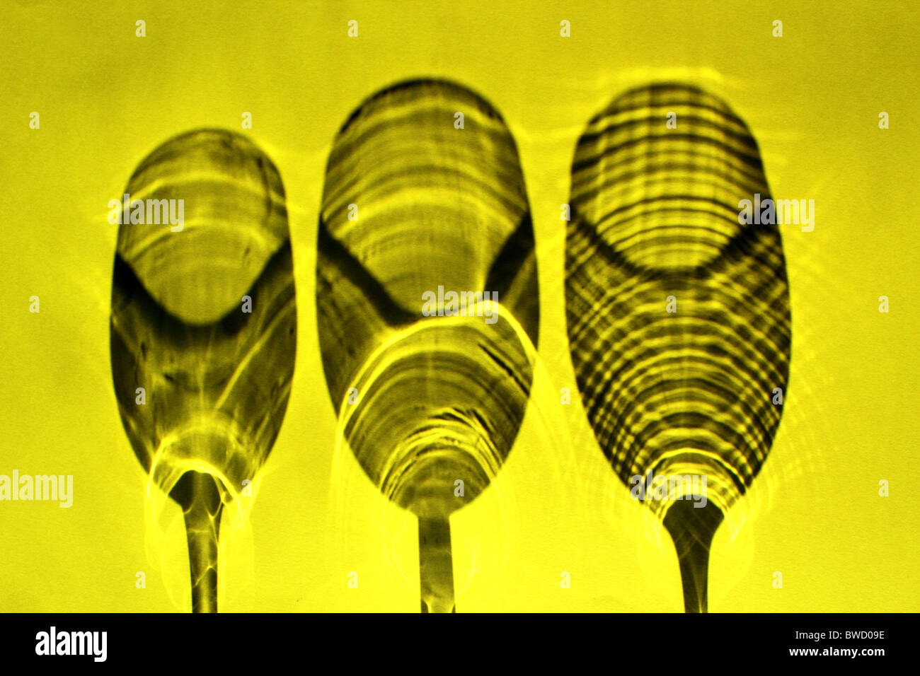 Shadows of three glasses shot on a yellow background Stock Photo - Alamy