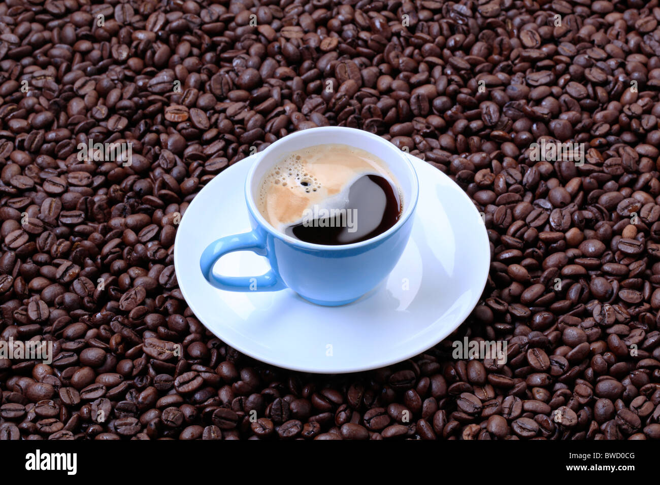 Cup of black coffee on a bed of coffee beans Stock Photo - Alamy