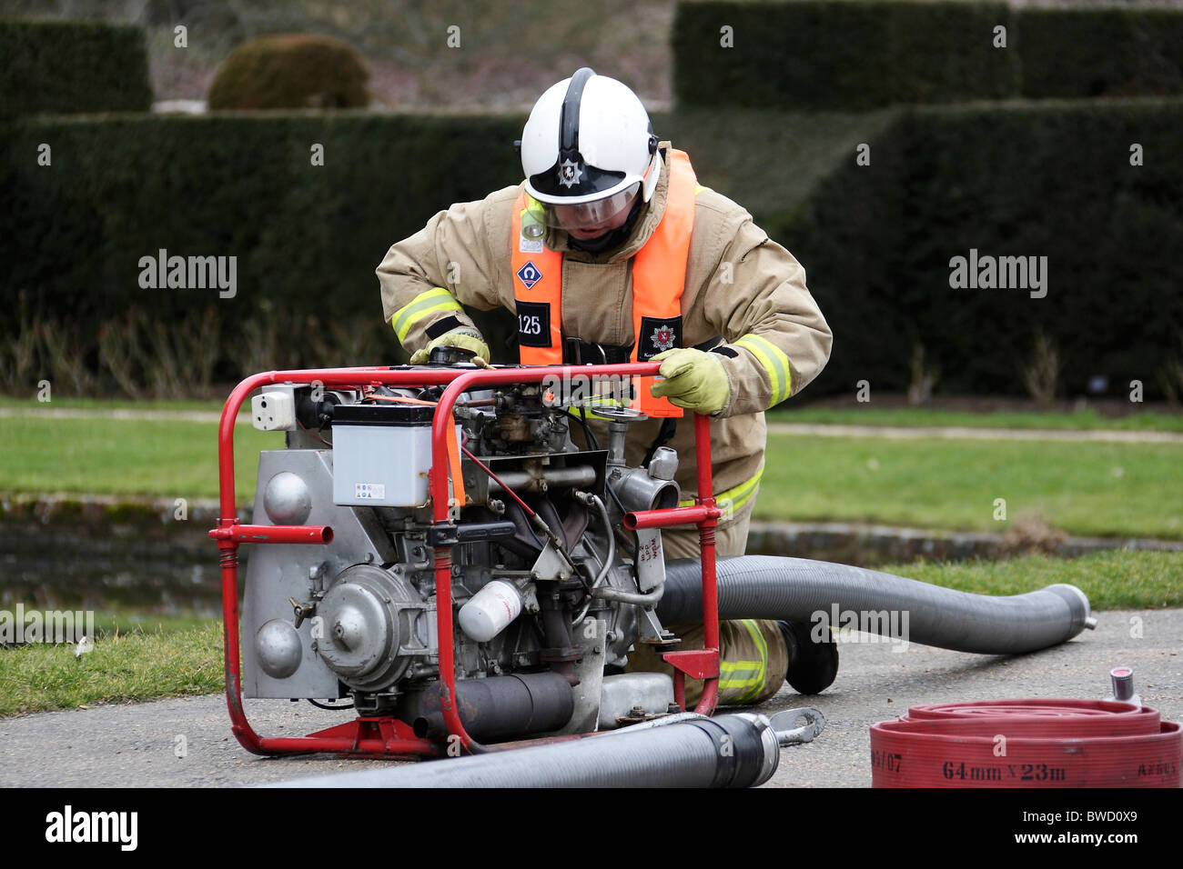 Fireman setting up a lightweight portable pump Stock Photo - Alamy