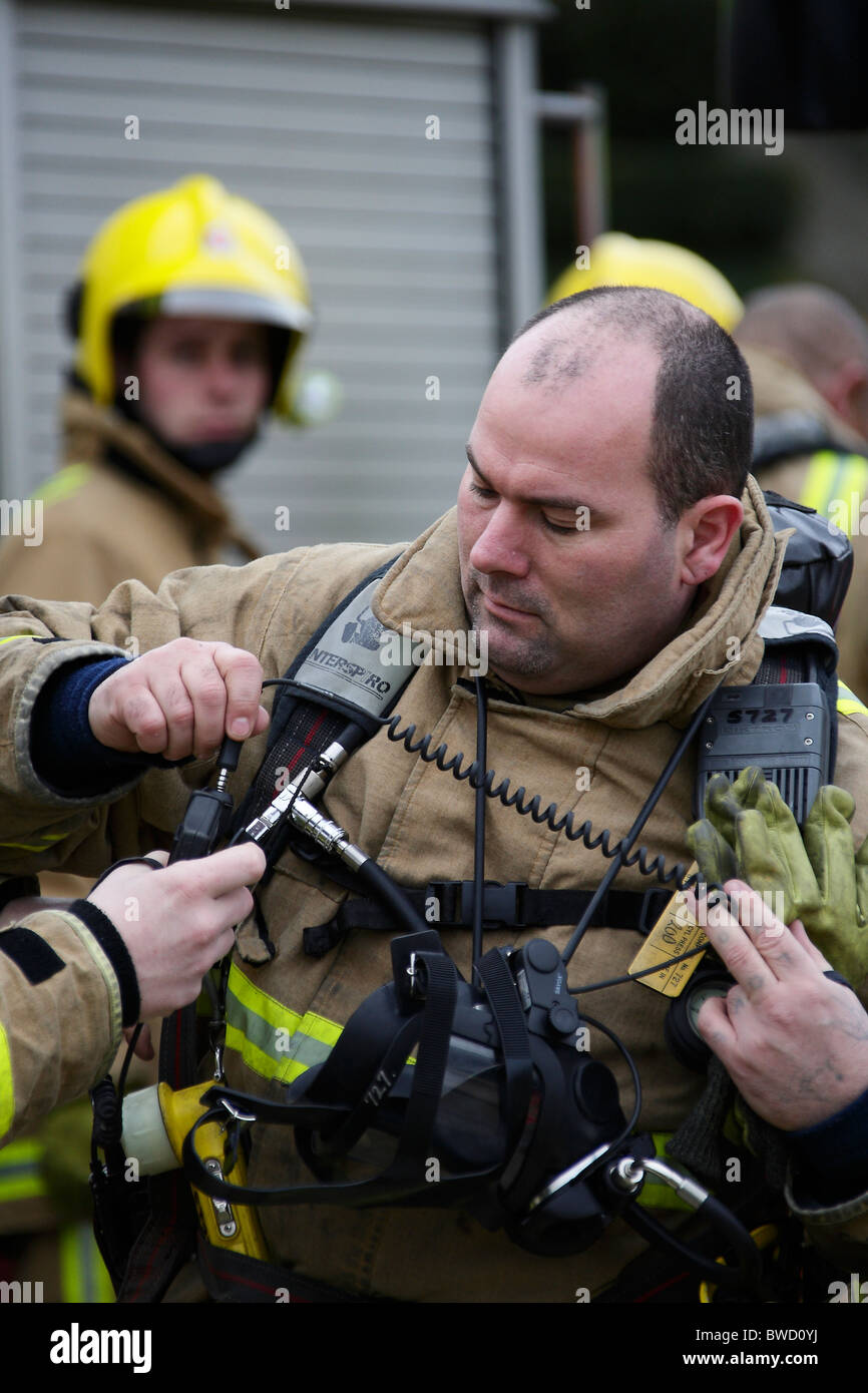Fireman putting on BA gear Stock Photo - Alamy