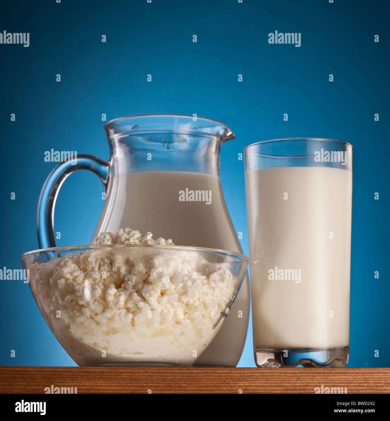 Milk and cottage cheese. On a blue background Stock Photo - Alamy