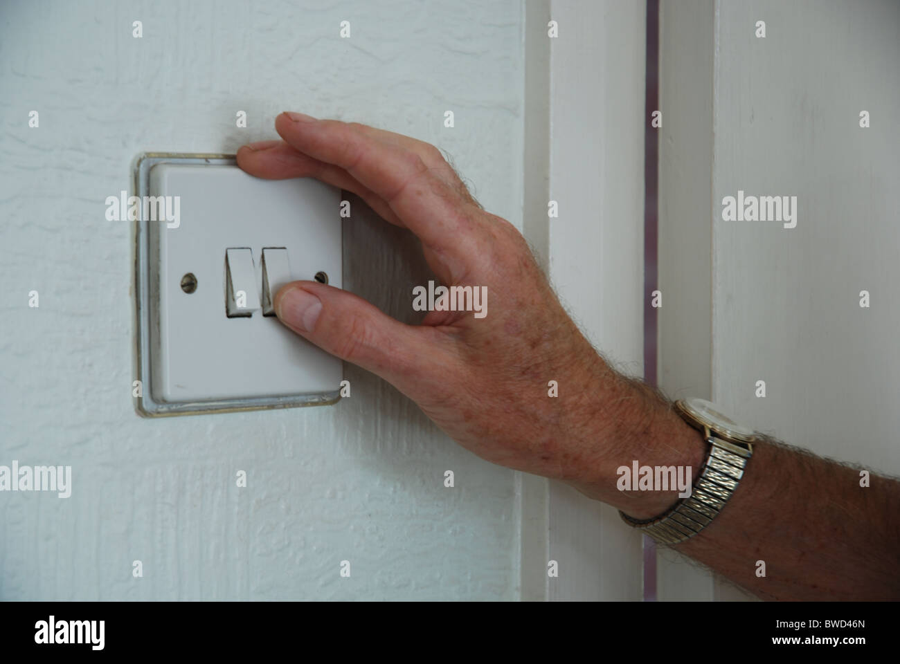 Man's hand on a house light switch Stock Photo - Alamy