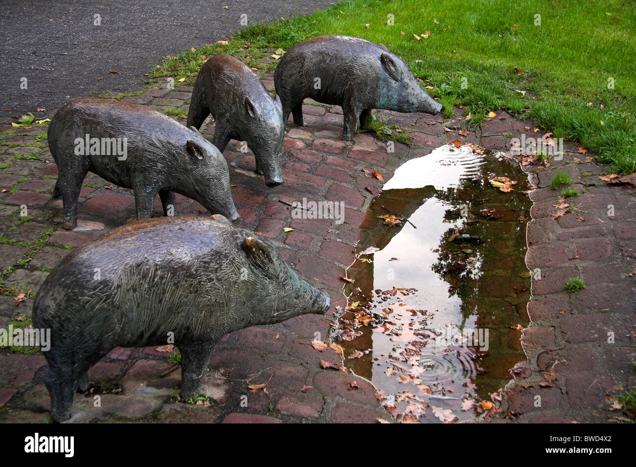 Wild boar sculptures, at a watering hole, Eberbach, Baden-Wurttemberg ...