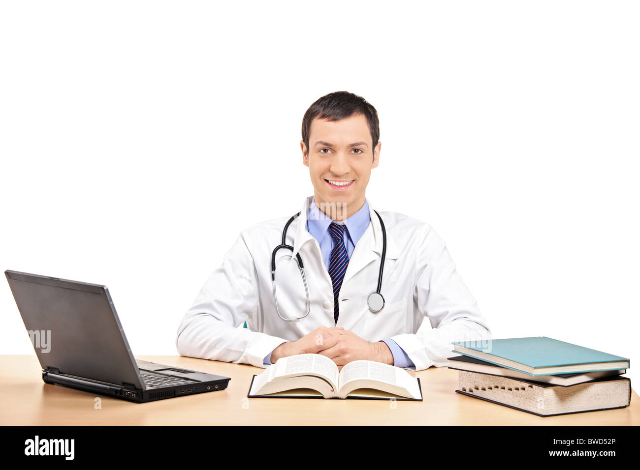 A doctor posing in his office, with laptop and many book Stock Photo ...