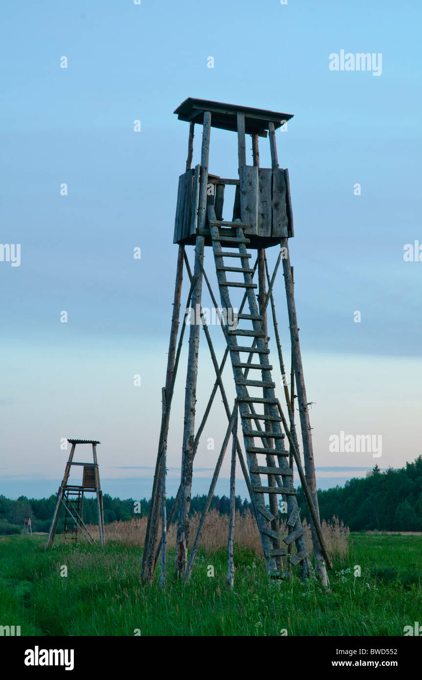 Hunting towers at dusk in northern Latvia Stock Photo - Alamy