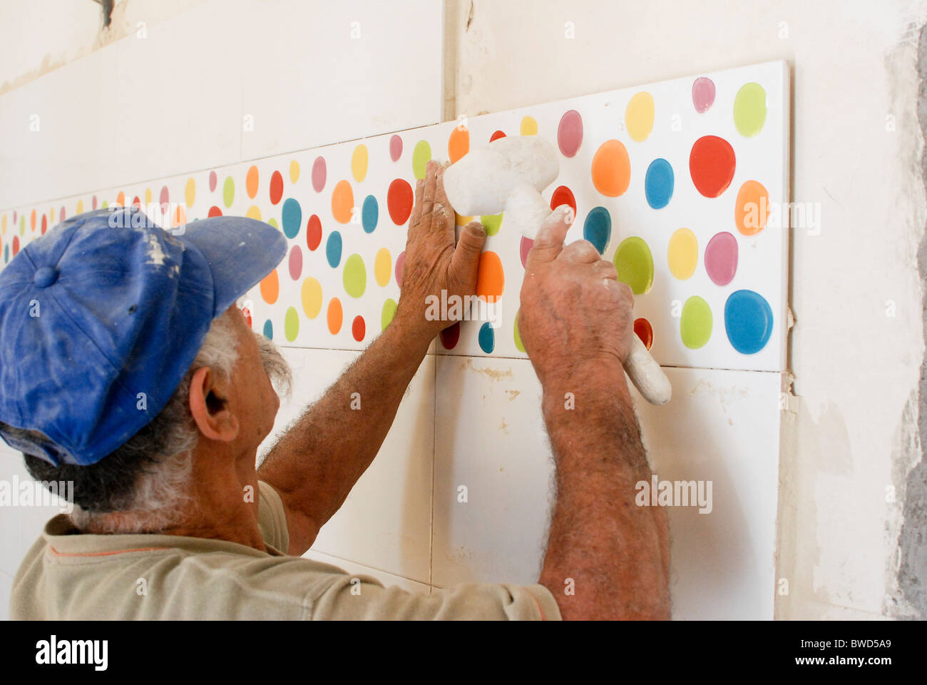 skilled Tiler at work laying tiles Stock Photo - Alamy