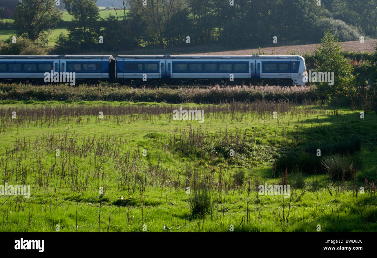 A train on a railway line in the countryside Stock Photo - Alamy