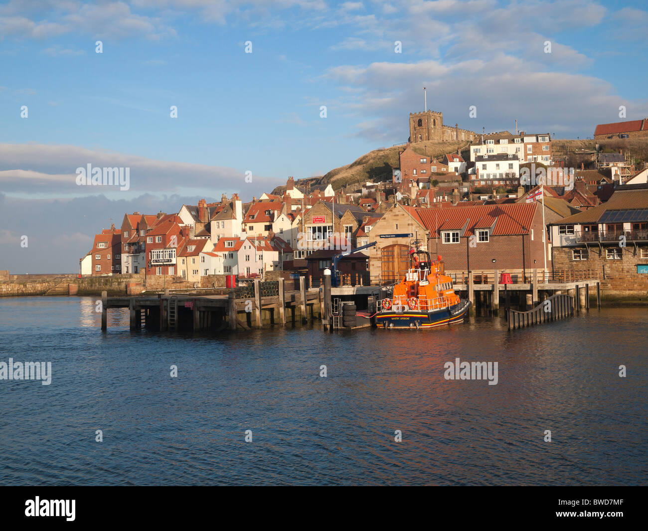 Whitby harbour with the lifeboat station and St Mary's church in autumn ...