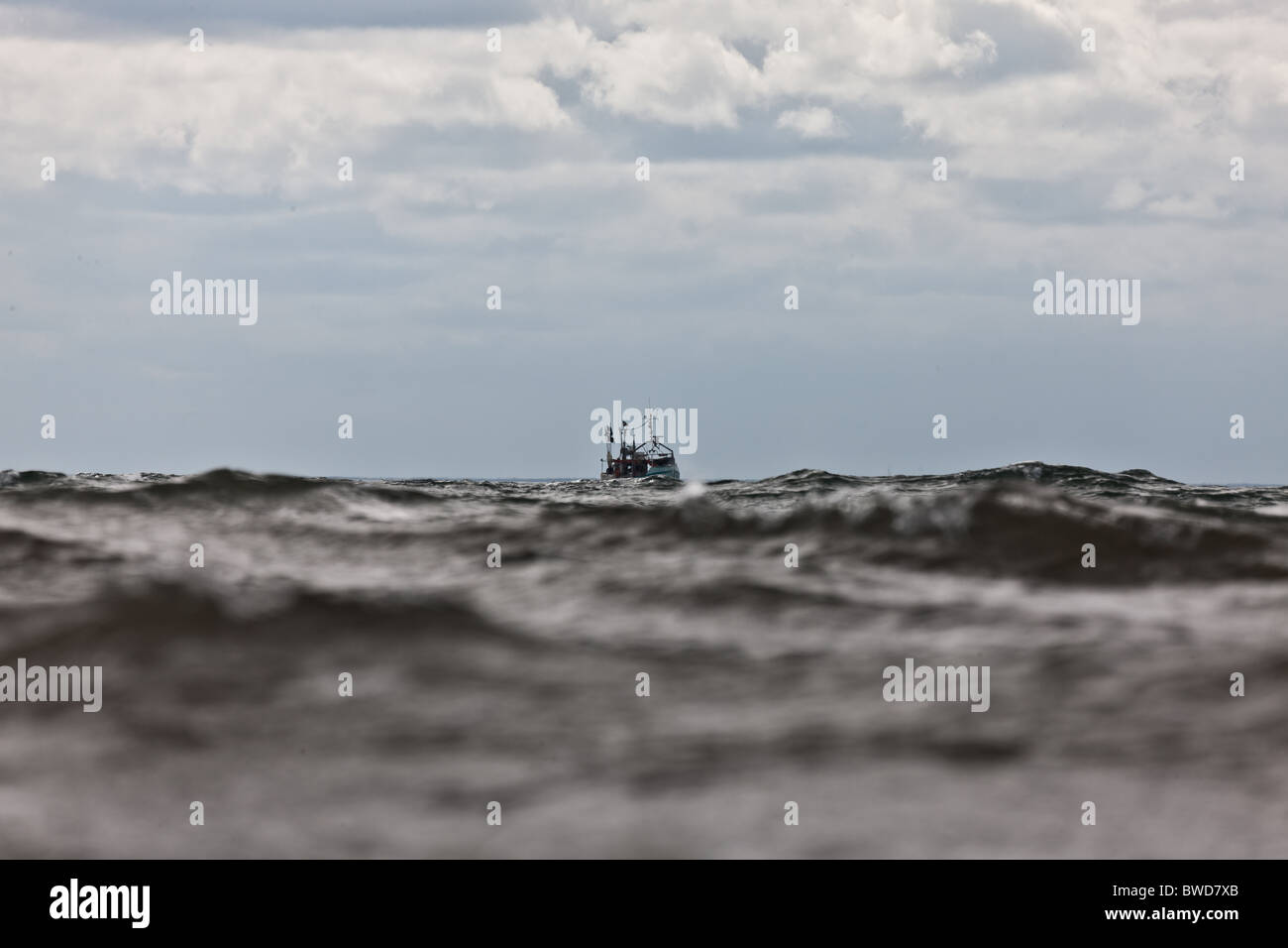 Fishing boat in bad weather Stock Photo - Alamy