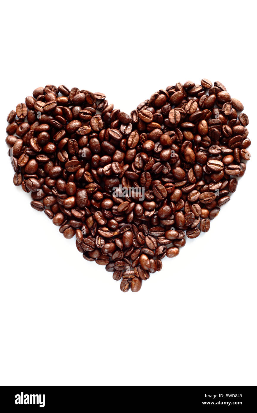 Heart shape symbol made from coffee beans on a pure white background ...