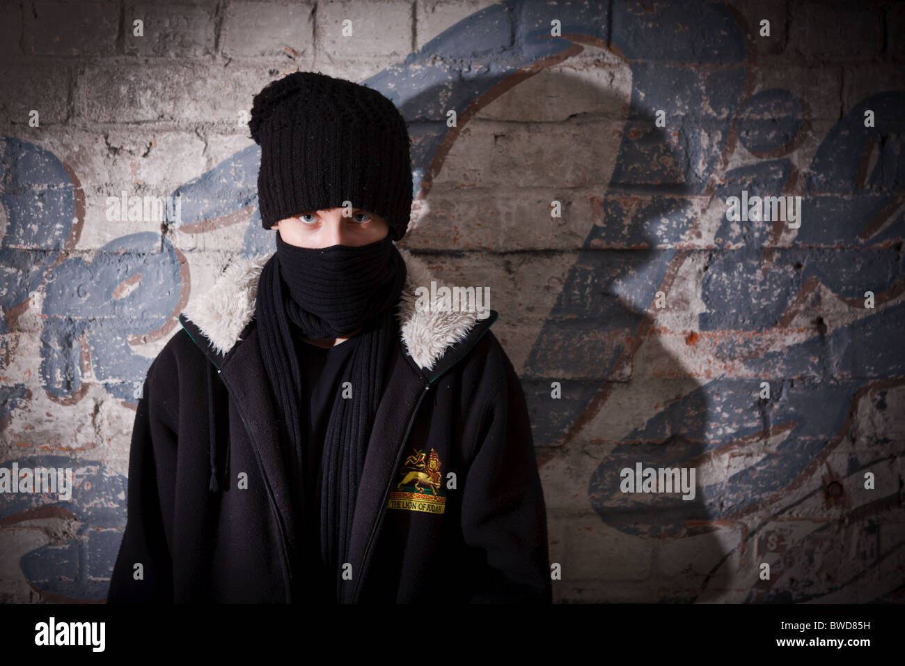 Young criminal with face covered Stock Photo - Alamy