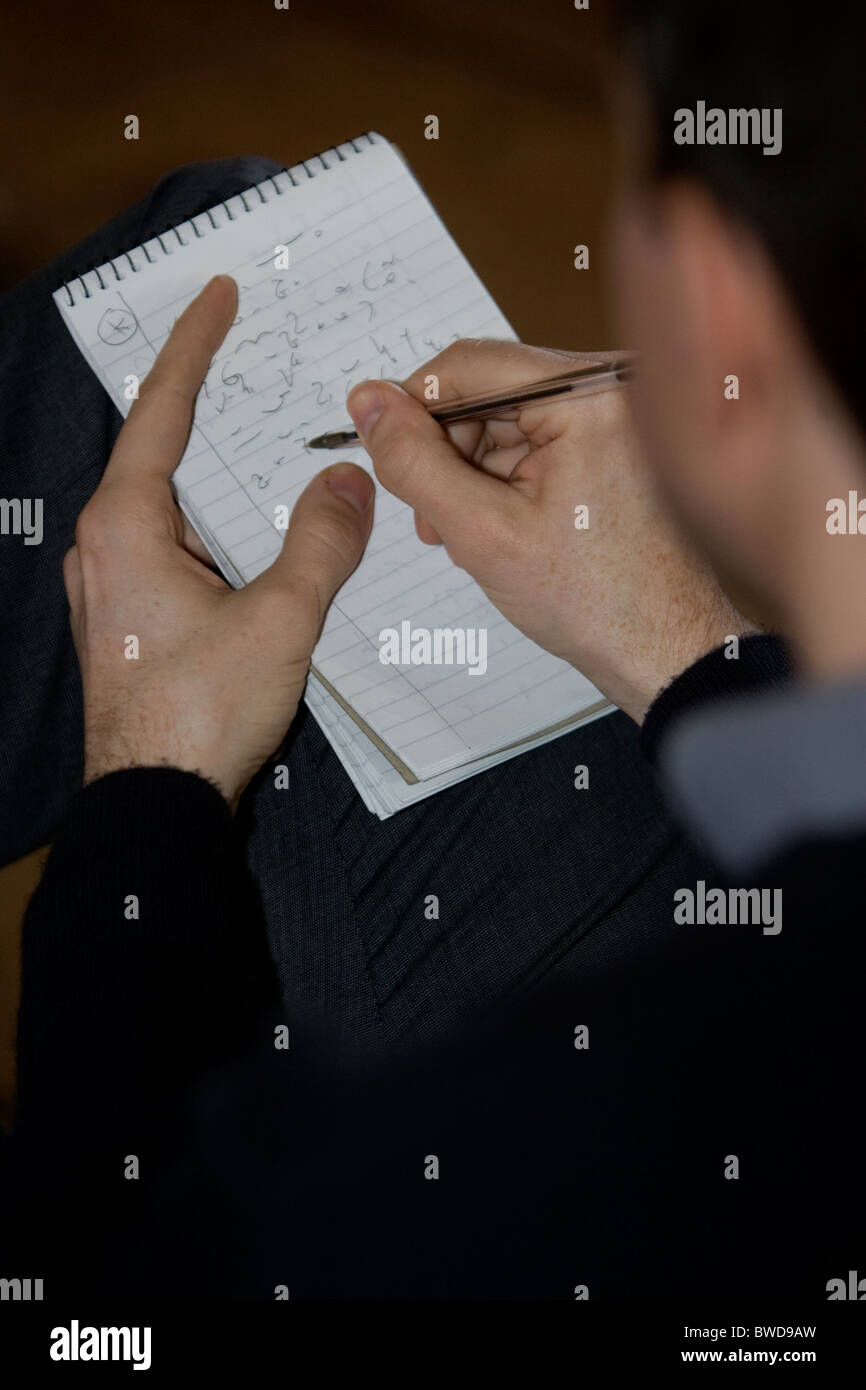 A reporter pictured writing in shorthand during an interview in London ...