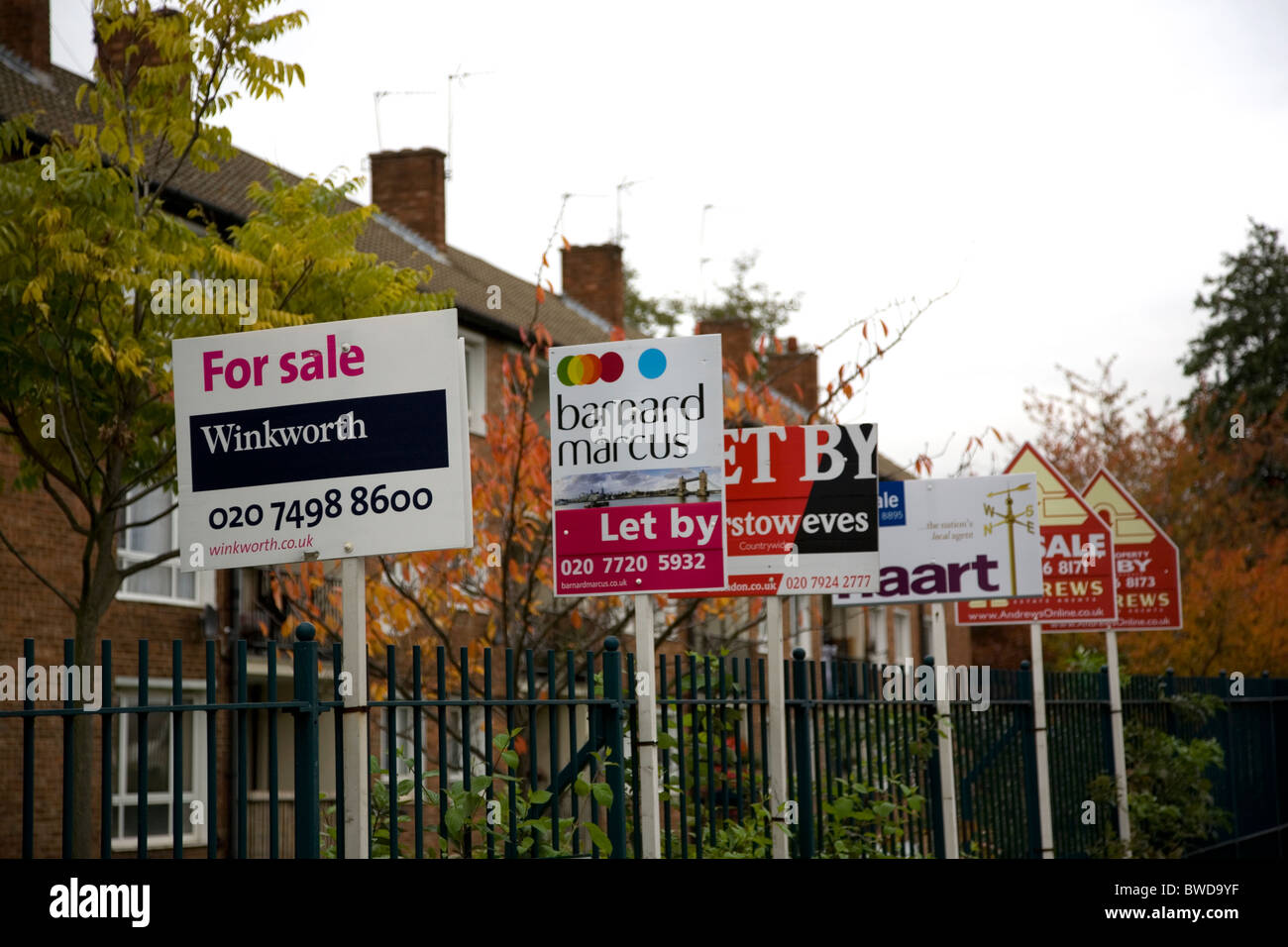 For Sale and Let signs on estate fence Stock Photo - Alamy