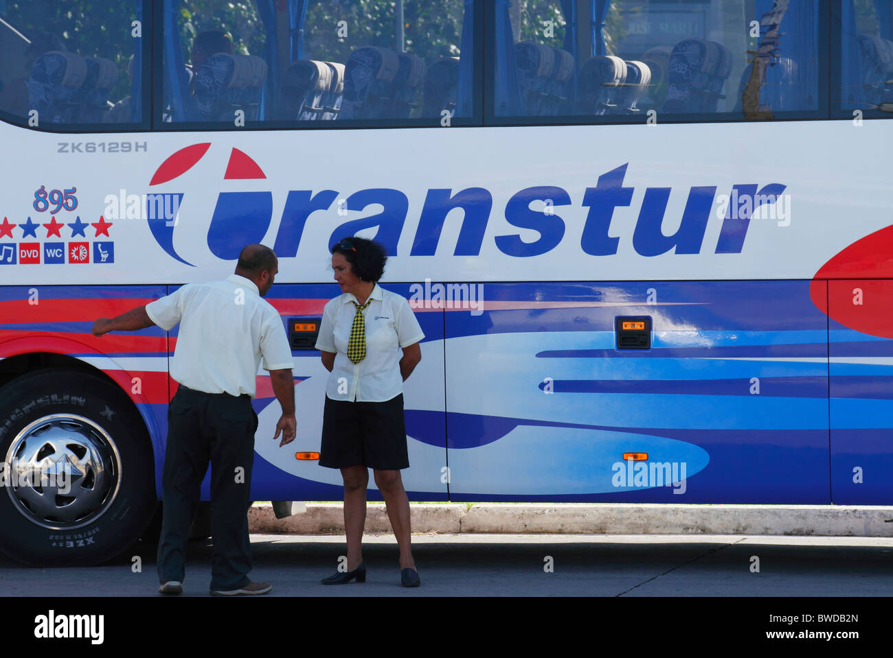 Cuban tourism workers and Transtur sightseeing tour bus. Habana ...
