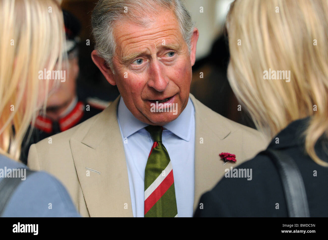 HRH Charles Prince of Wales chats to two blonde women Stock Photo - Alamy