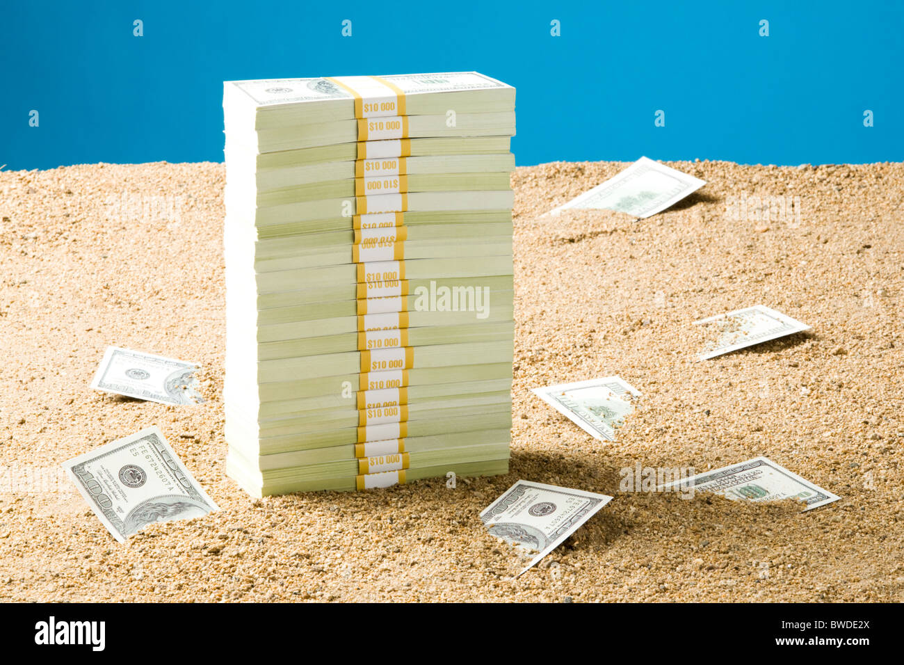 Stack of many hudred dollar banknotes on sand Stock Photo - Alamy