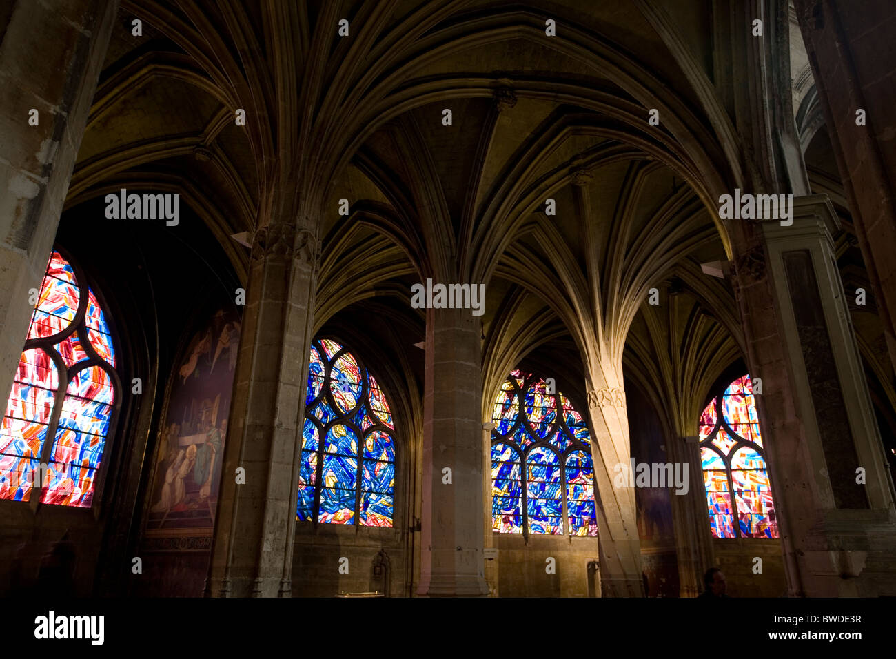 vaulted ceiling, gothic arches and stained-glass windows inside st ...