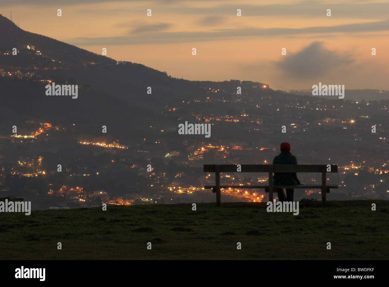 Lonely woman sitting on a bench at sunset Stock Photo - Alamy