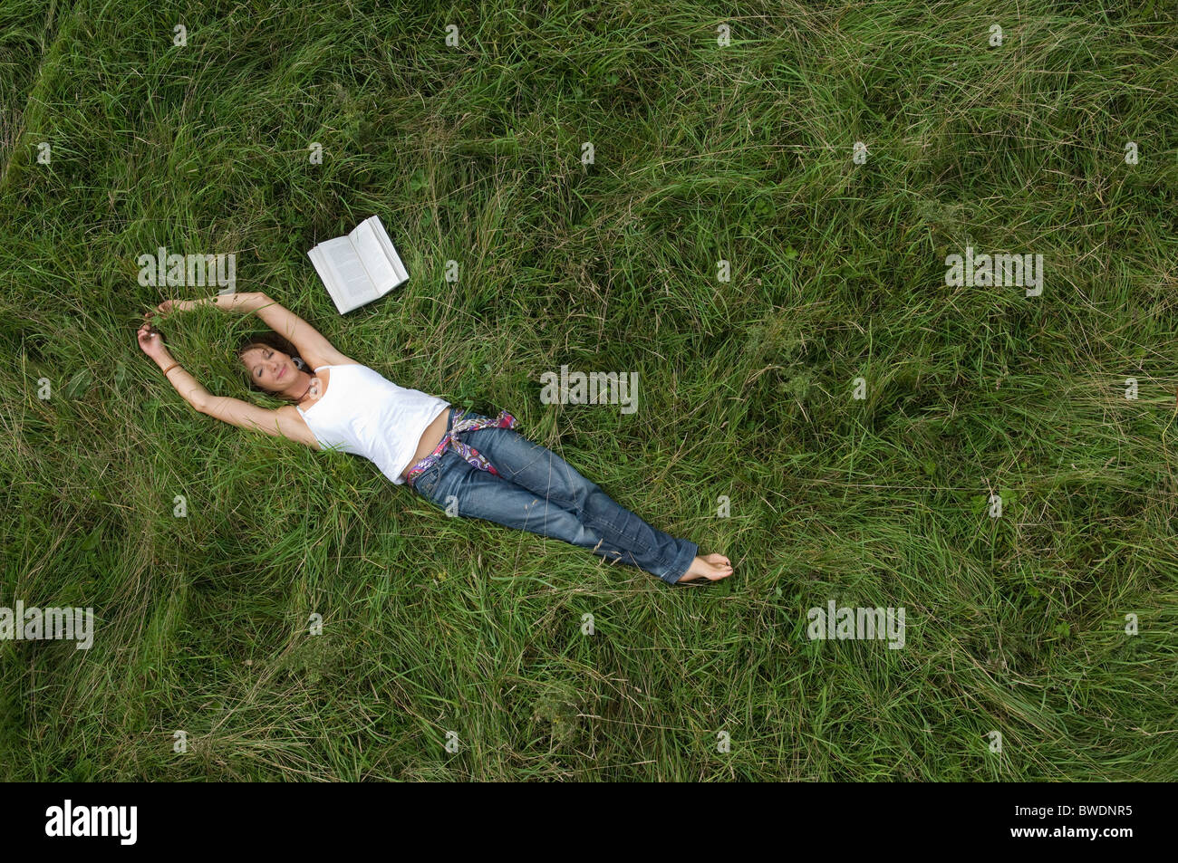 Female relaxing in field Stock Photo - Alamy