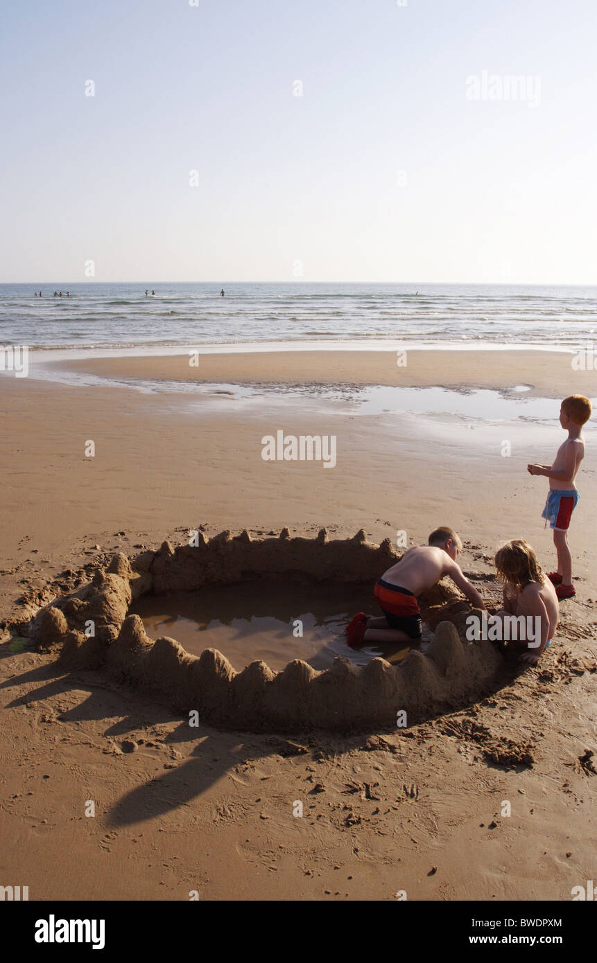 Children building a sand castle hi-res stock photography and images - Alamy