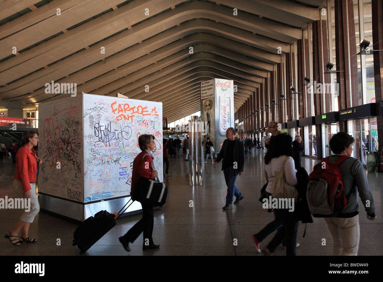 Rome Termini station concourse with giant paper cube on which people ...