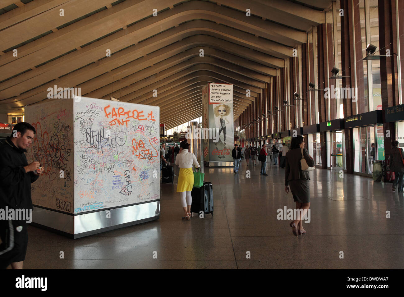 Rome Termini station concourse with giant paper cube on which people ...