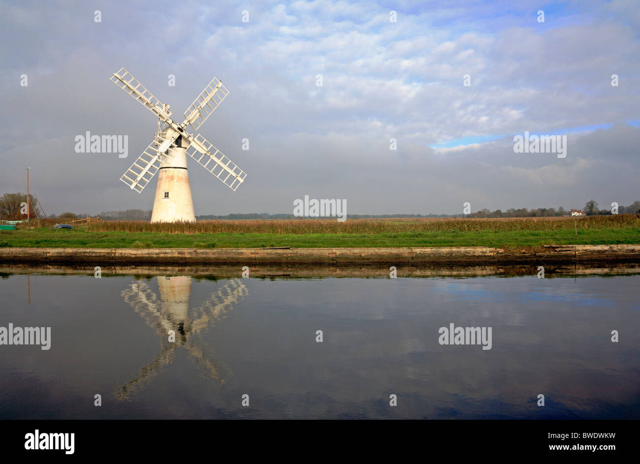 Thurne Mill and reflection on the Norfolk Broads in winter set against ...