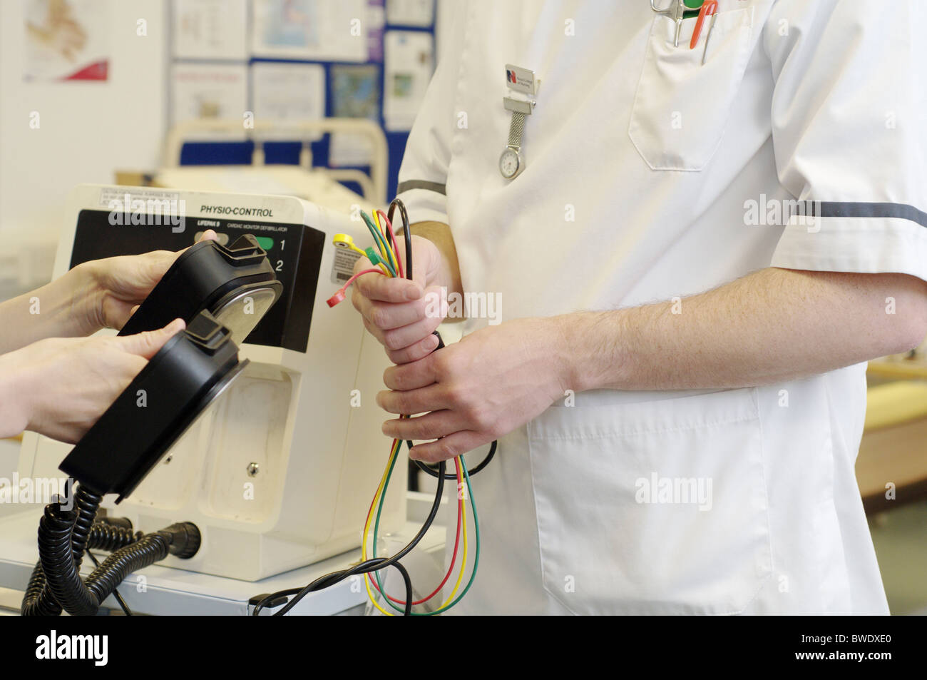 Medical staff using a defibrillator in a training ward in a hospital ...