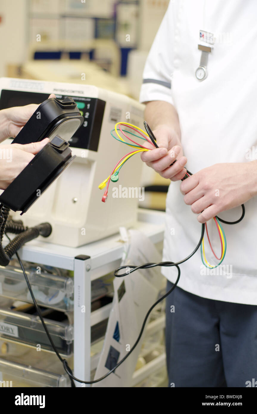 Medical staff using a defibrillator in a training ward in a hospital ...