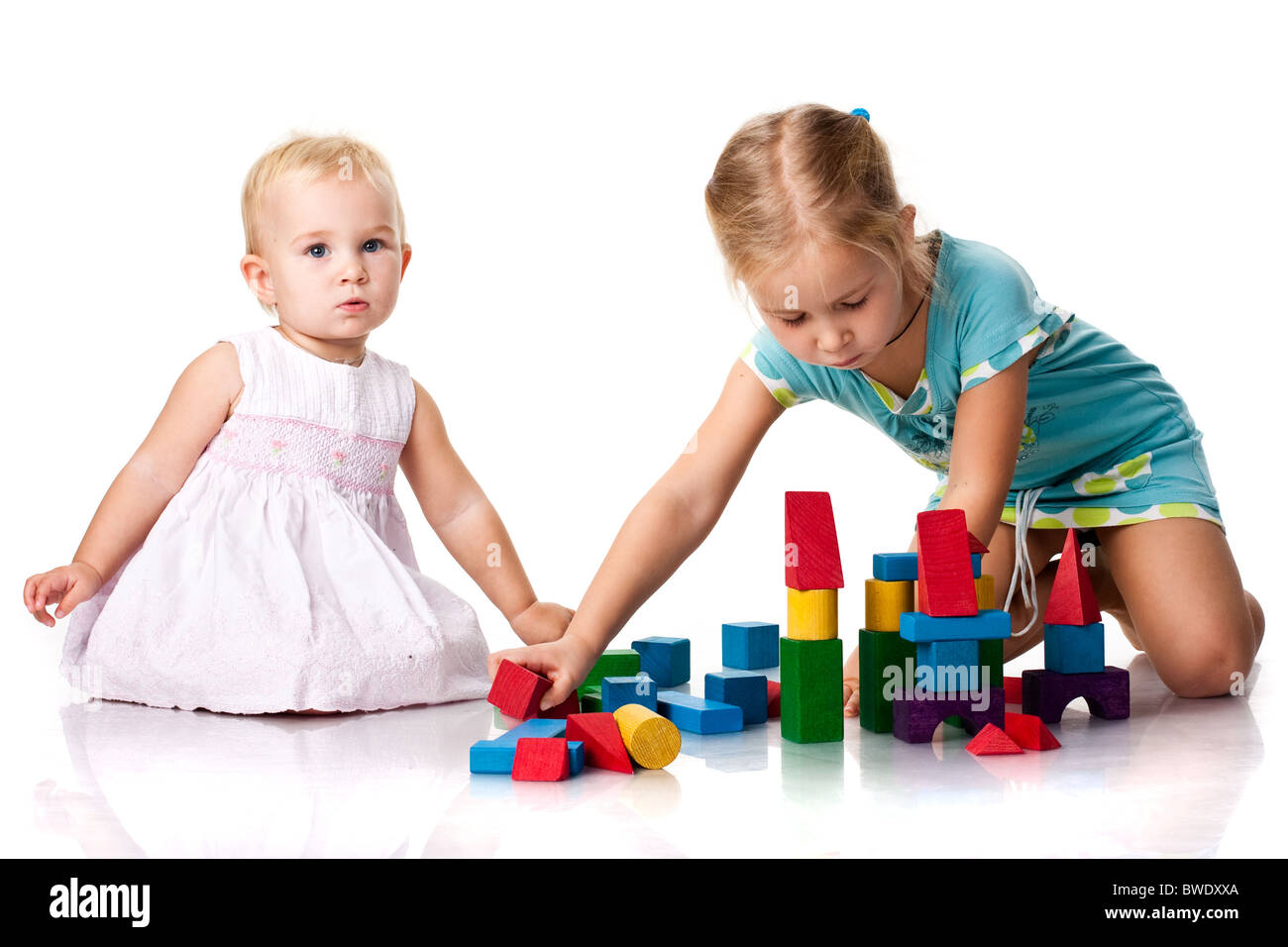 Children building a castle with cubes isolated on white Stock Photo - Alamy